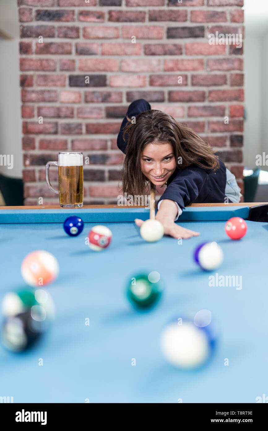 Portrait of pretty young female playing billiards Stock Photo - Alamy