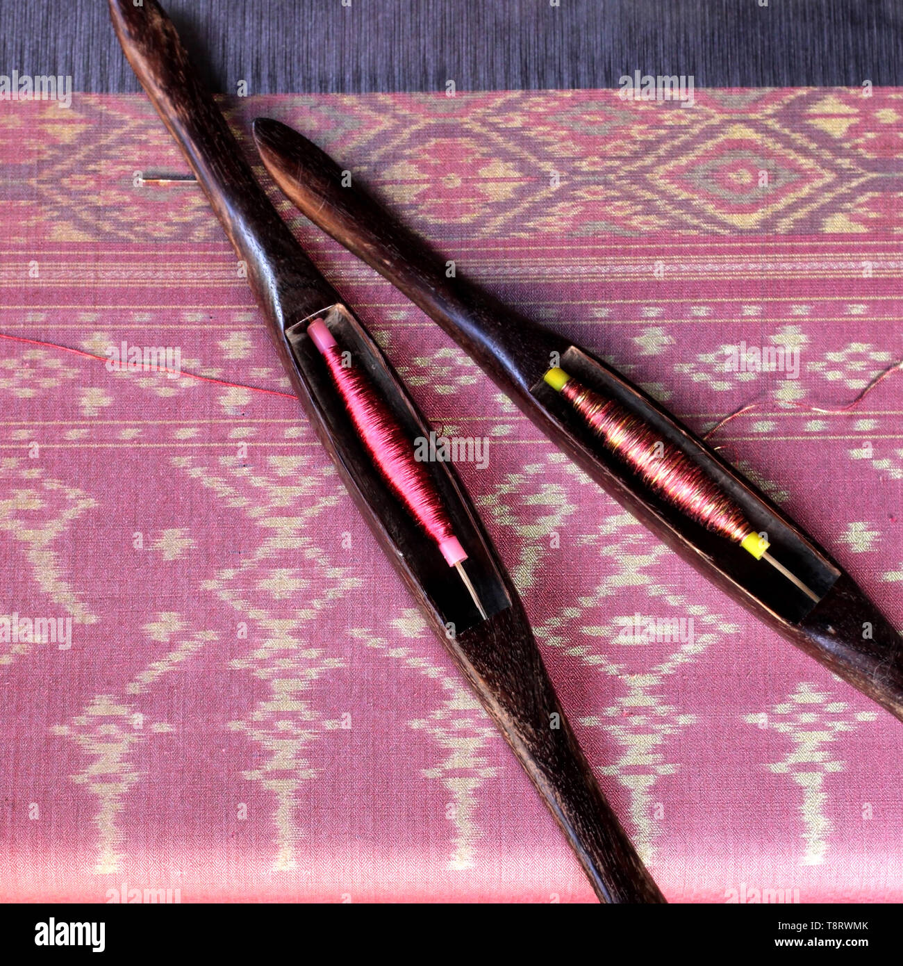 wooden bobbin on silk fabric, traditional weaving of Thai silk Stock ...