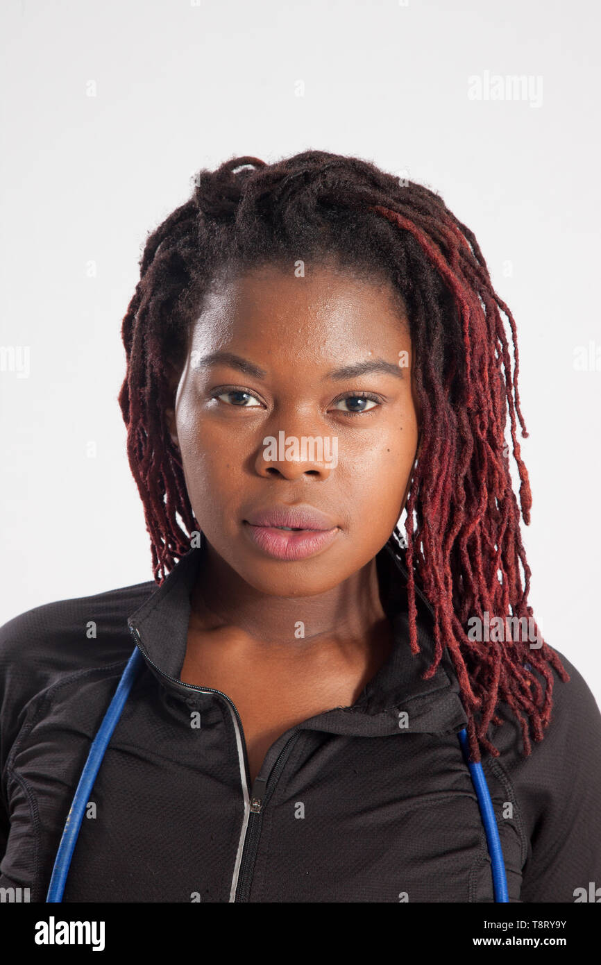 Lovely Black woman in exercise outfit with a pull rope Stock Photo - Alamy