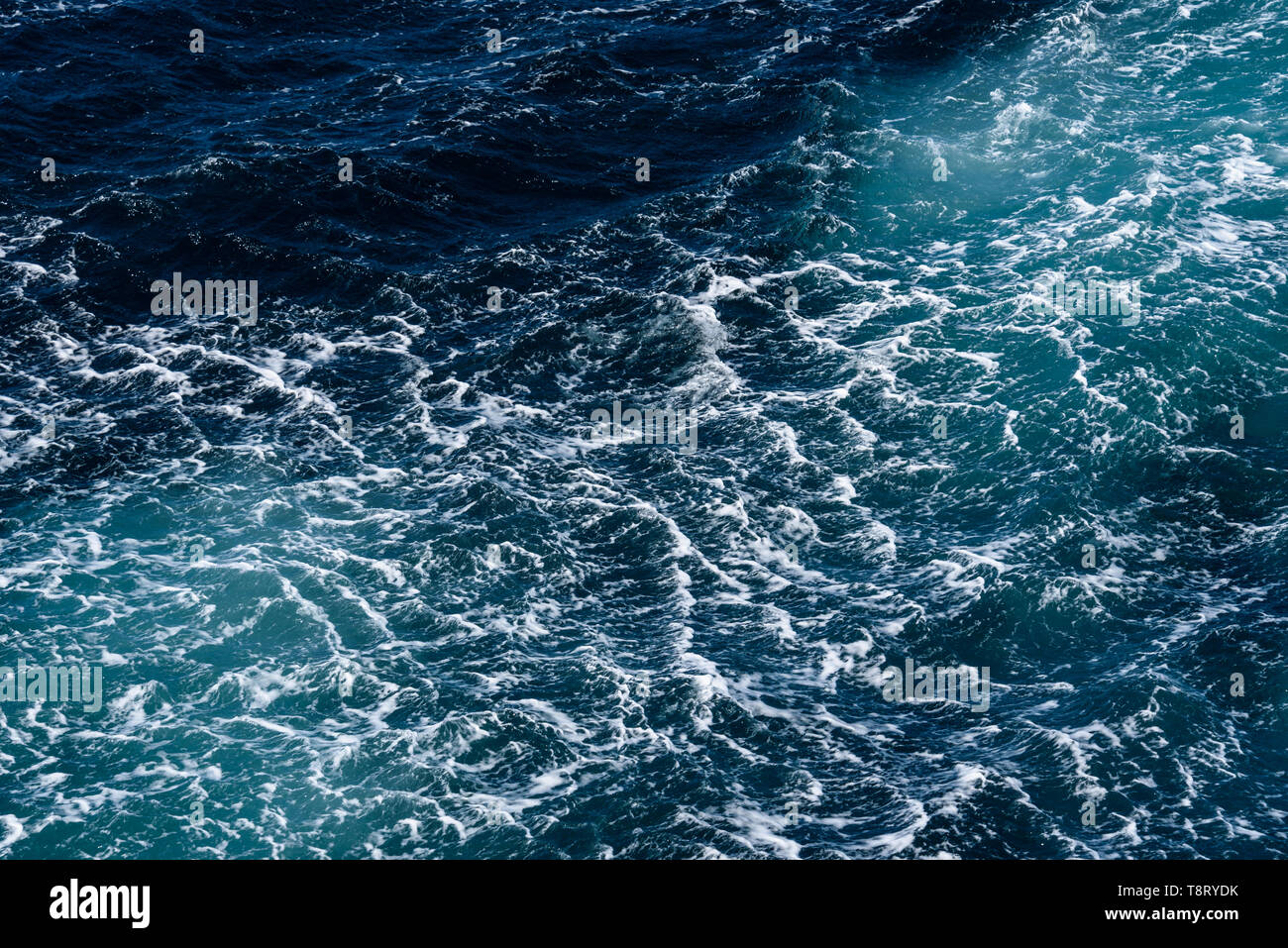 Turquoise and blue ocean water with bubbles and waves as a nature ...