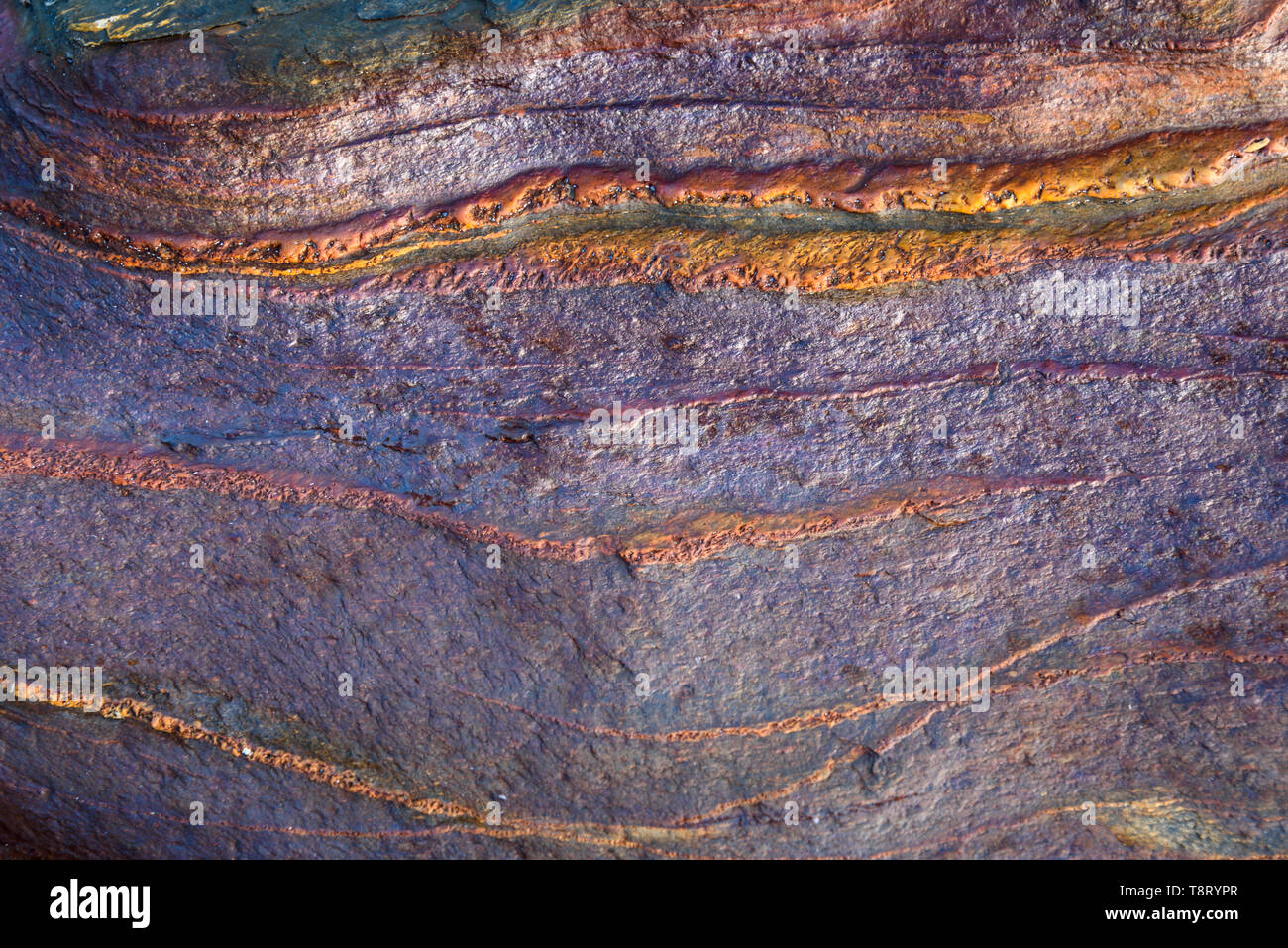 Smooth stone with purple and orange pattern, as a nature background ...