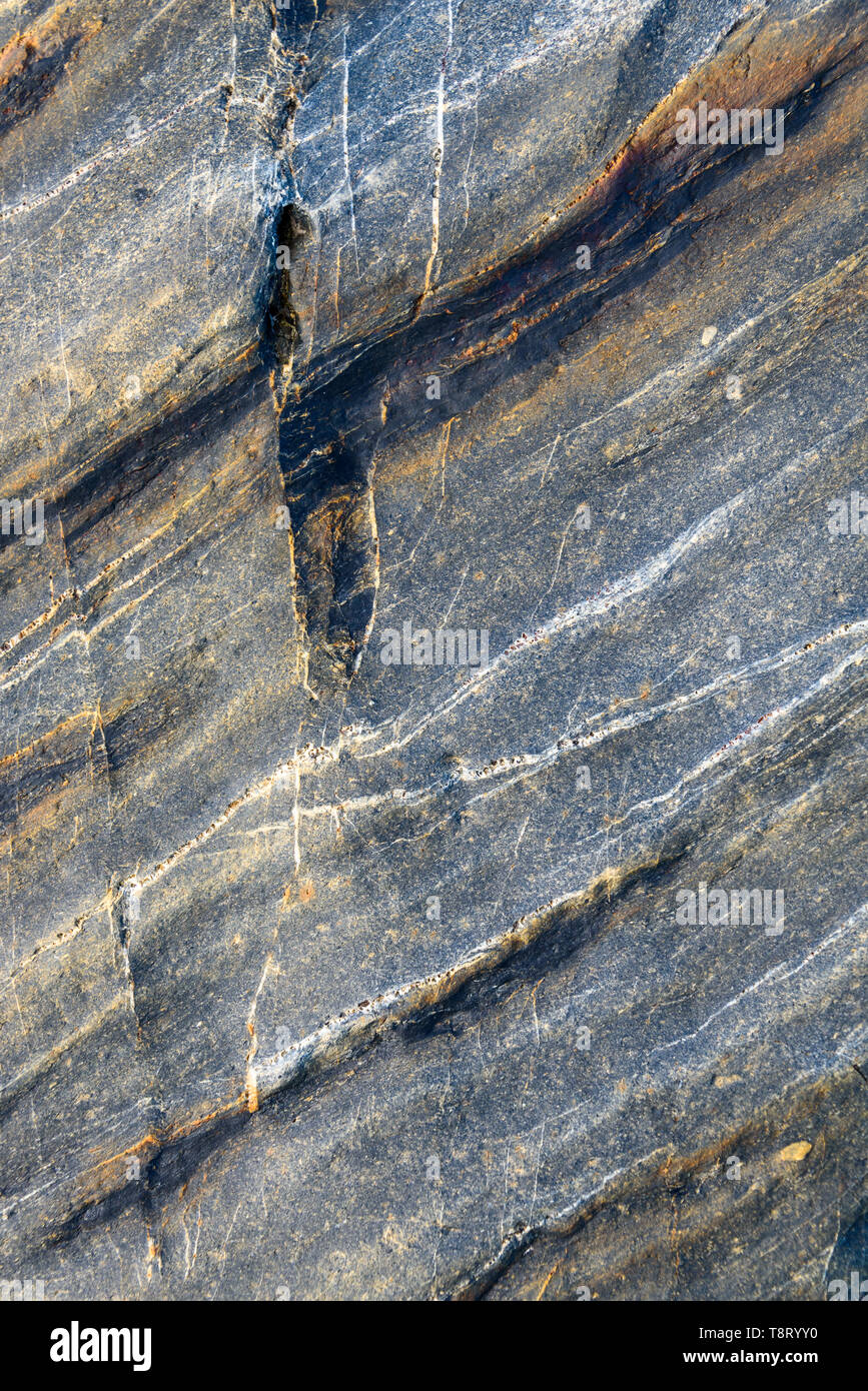 Blue gray stone with white and orange diagonal lines of pattern and ...