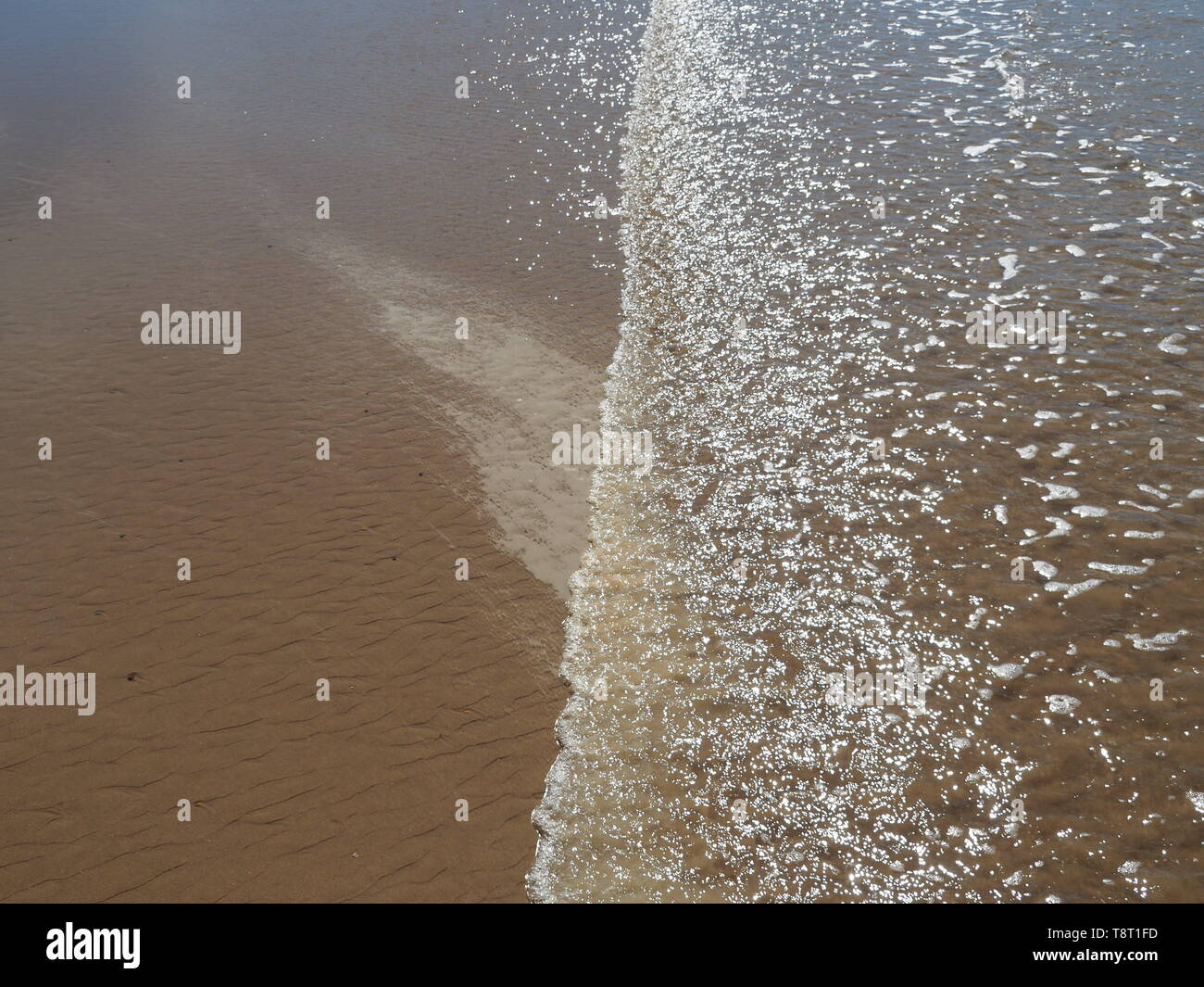 Seaside patterns with water and sand Stock Photo - Alamy