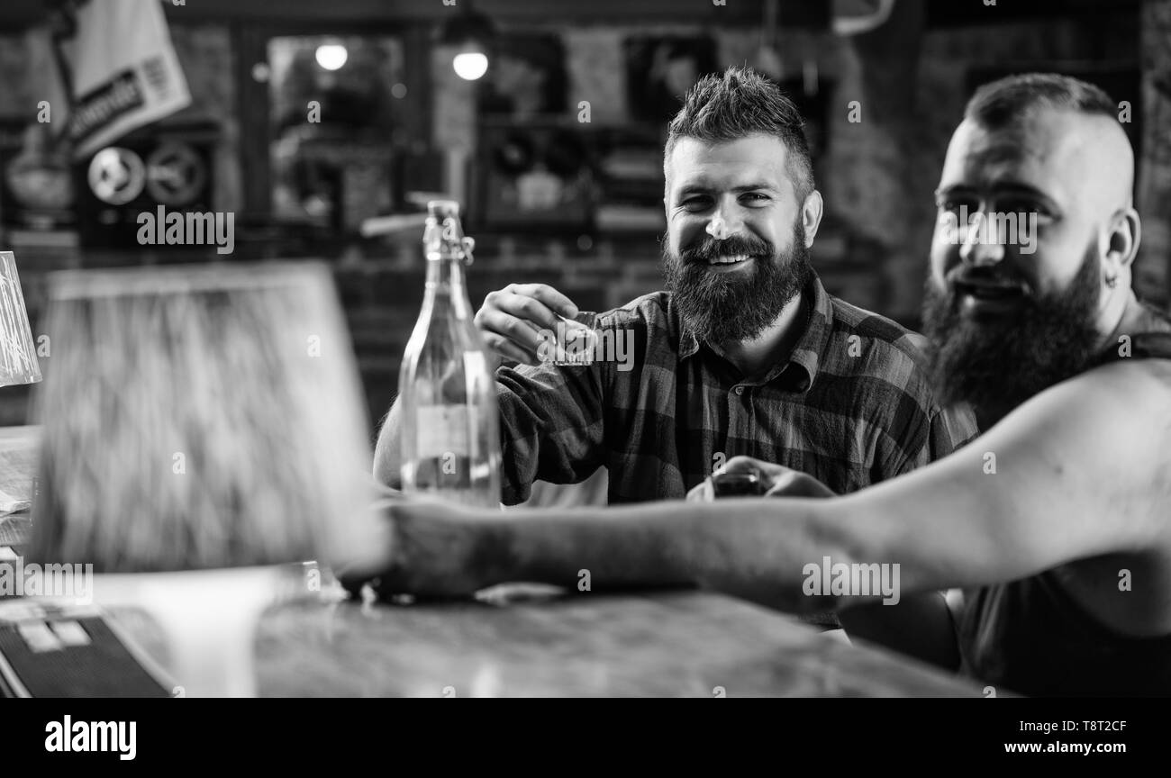 Strong alcohol drinks. Friends relaxing in pub. Alcohol addiction. Men ...