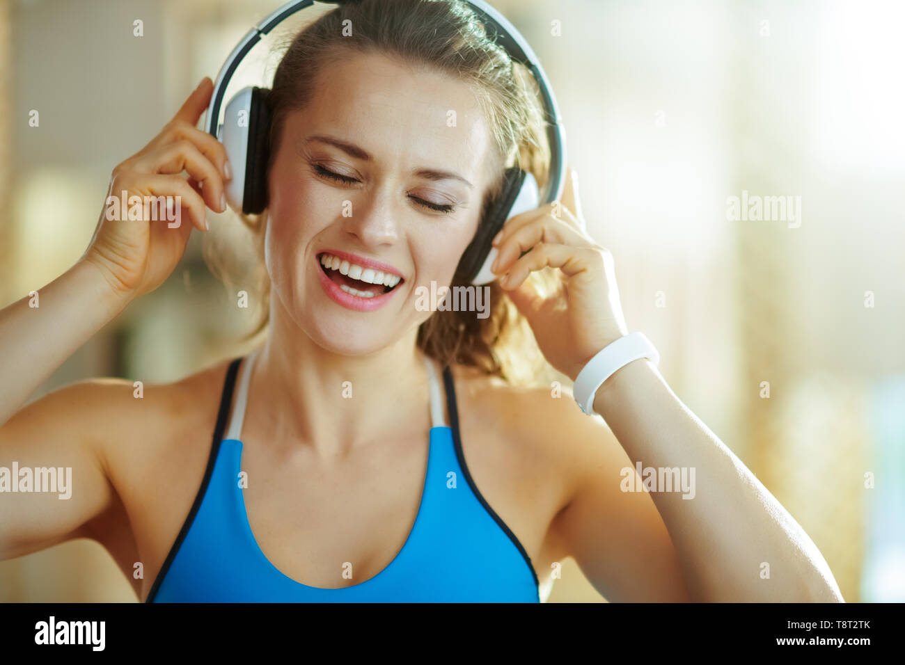 happy active woman in sport clothes listening to the music with ...
