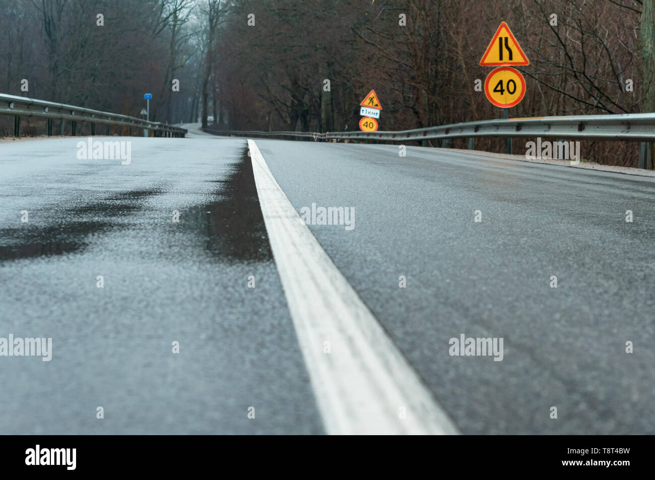wet asphalt, solid white markings on the road Stock Photo - Alamy