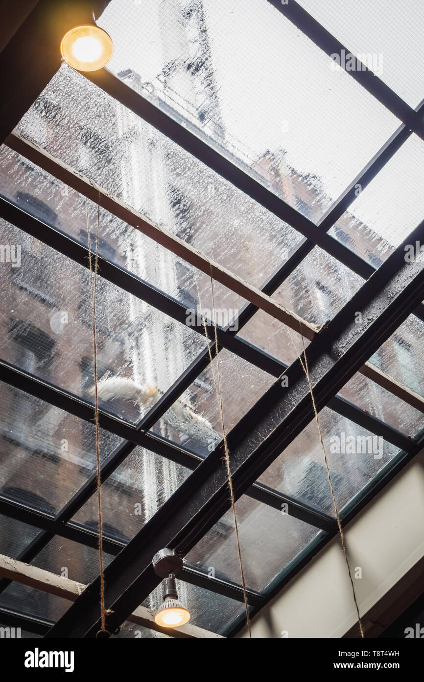 Rainy day under the glass roof of a building in New York City Stock ...