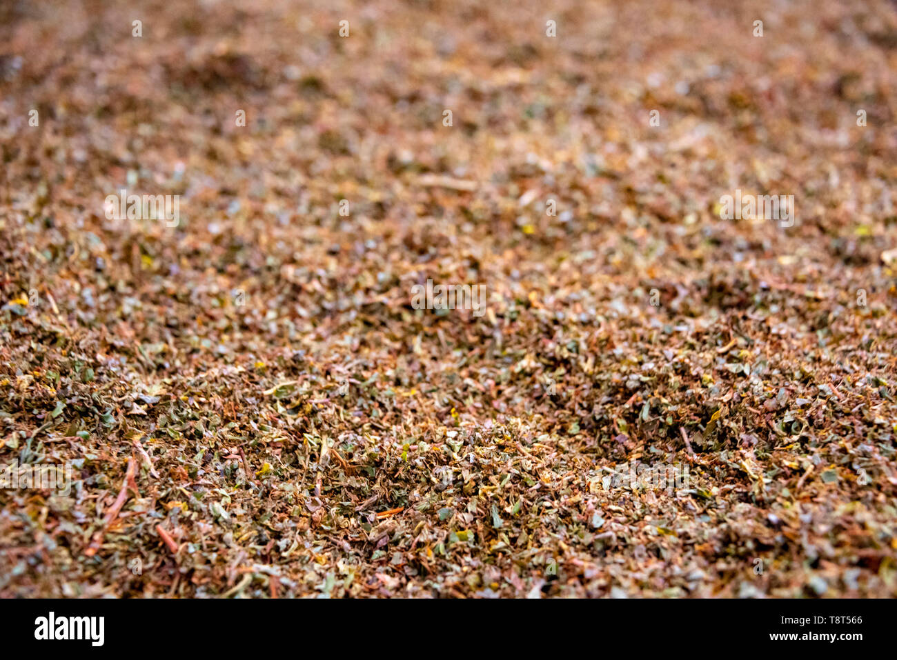 Horizontal close up of loose tea at the end of the production line at a ...