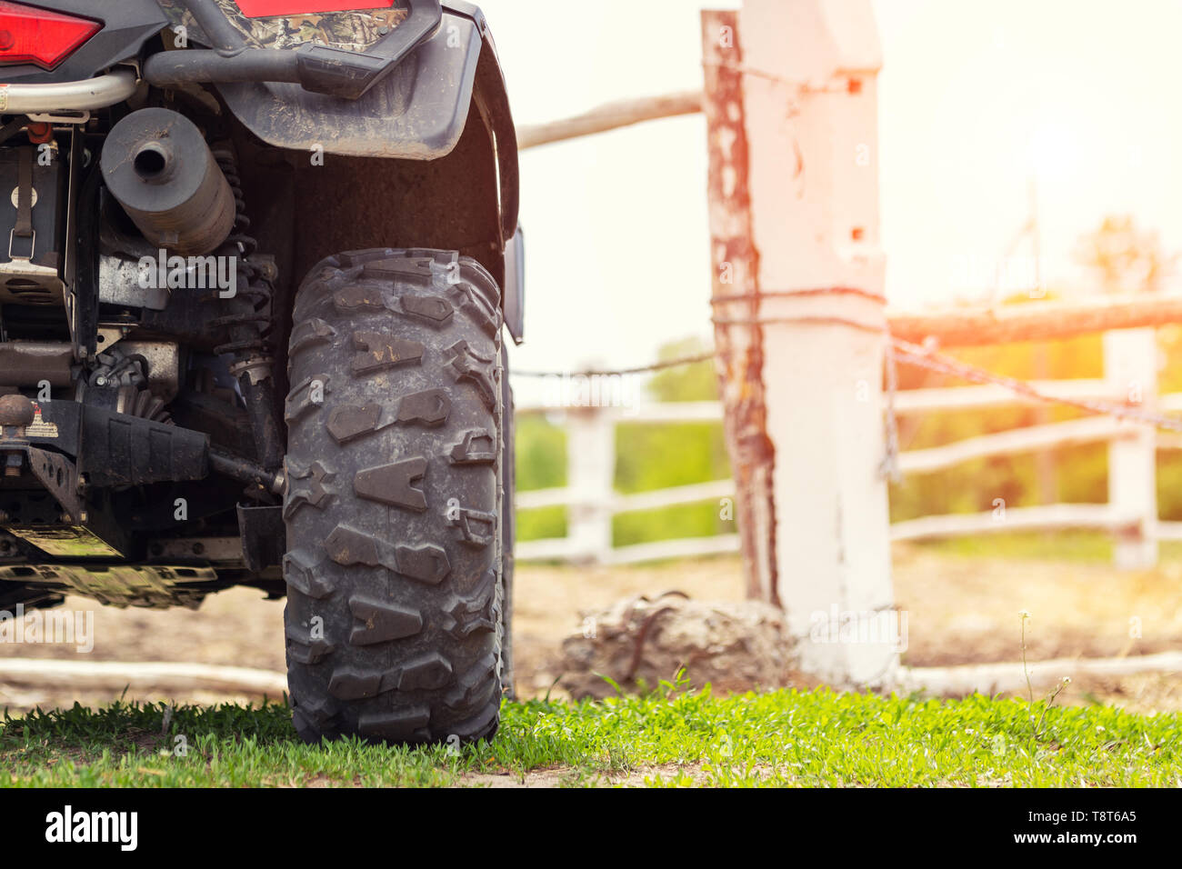 ATV quad bike vehicle standing near wooden fence at farm or horse ...