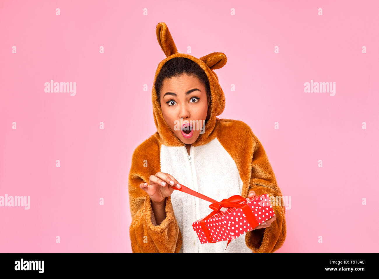 Young Woman In Bunny Kigurumi Standing Isolated On Pink Background