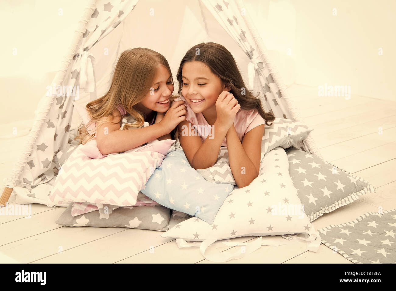 Share secrets concept. Girls cute children lay relaxing in teepee ...