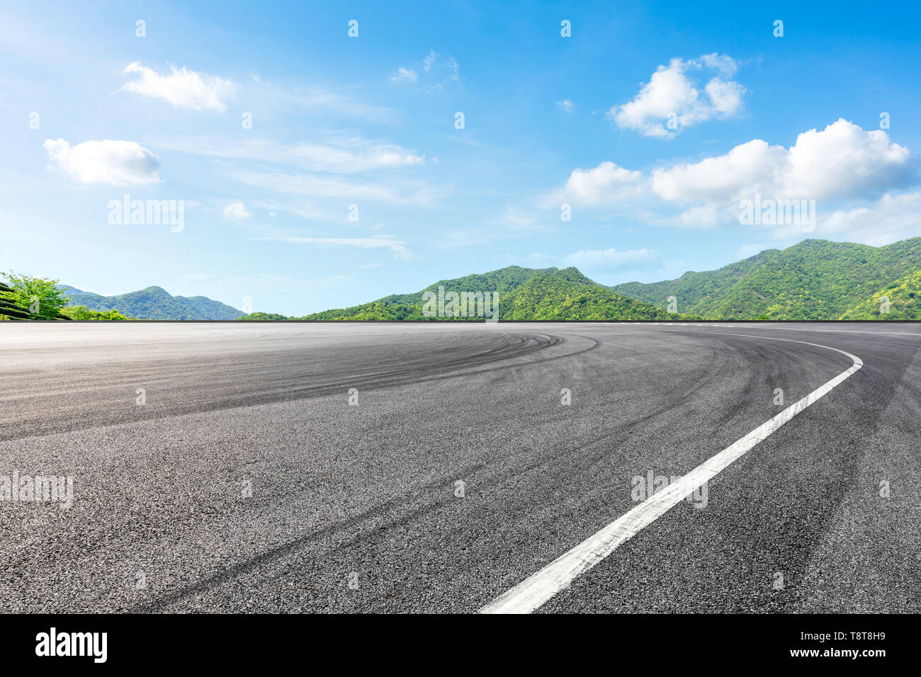 Asphalt race track ground and green mountains natural landscape Stock ...