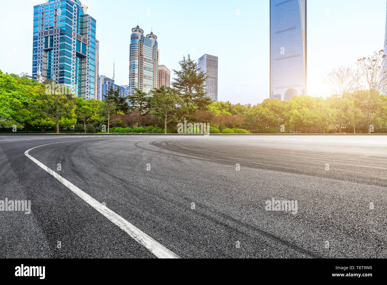 Asphalt race track and modern commercial office building in Shanghai ...