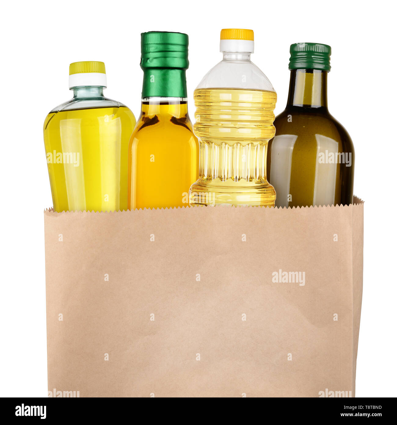 Oil bottles in paper bag isolated on white background Stock Photo - Alamy