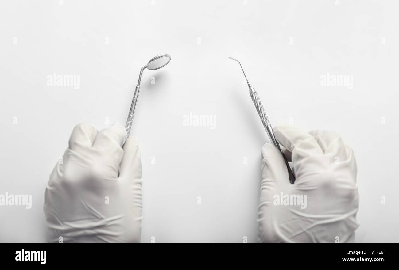 Dentist with tools on white background Stock Photo - Alamy
