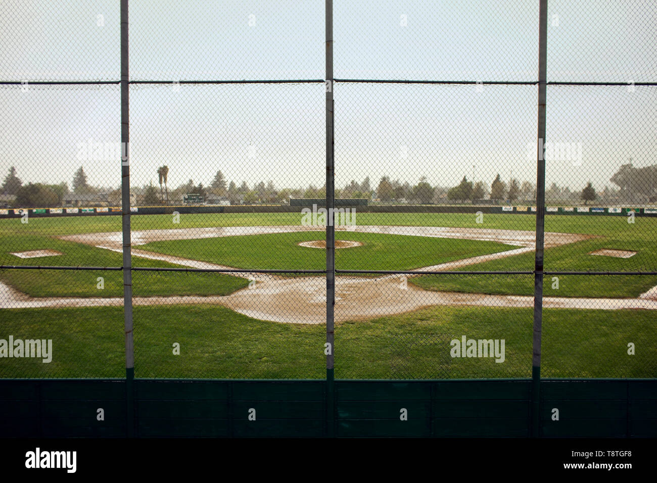 Empty baseball field surrounded by a chain link fence Stock Photo - Alamy