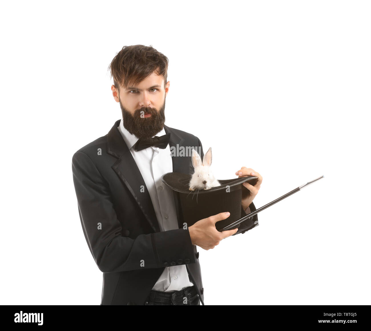 Magician holding hat with rabbit on white background Stock Photo - Alamy