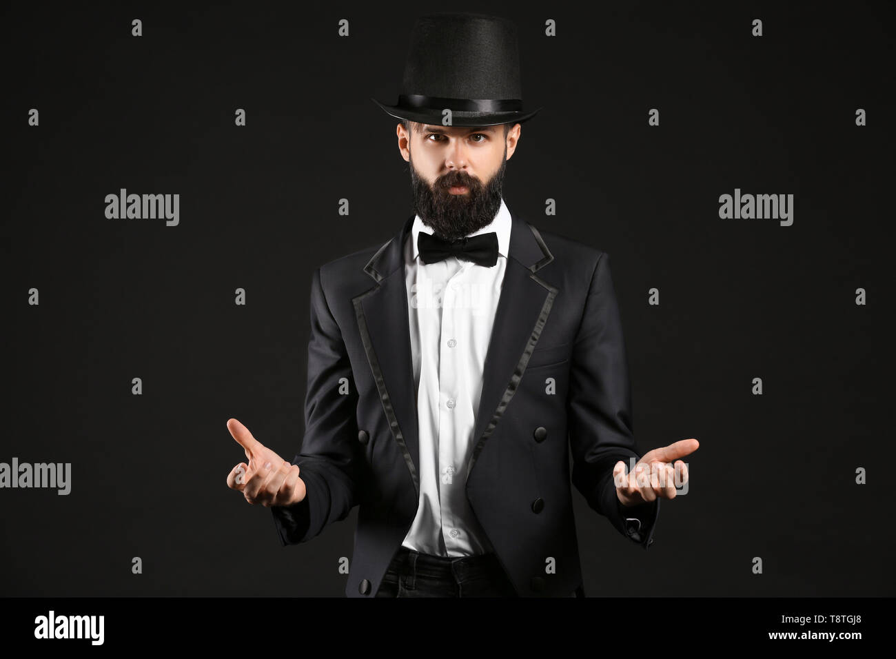 Male magician on dark background Stock Photo - Alamy