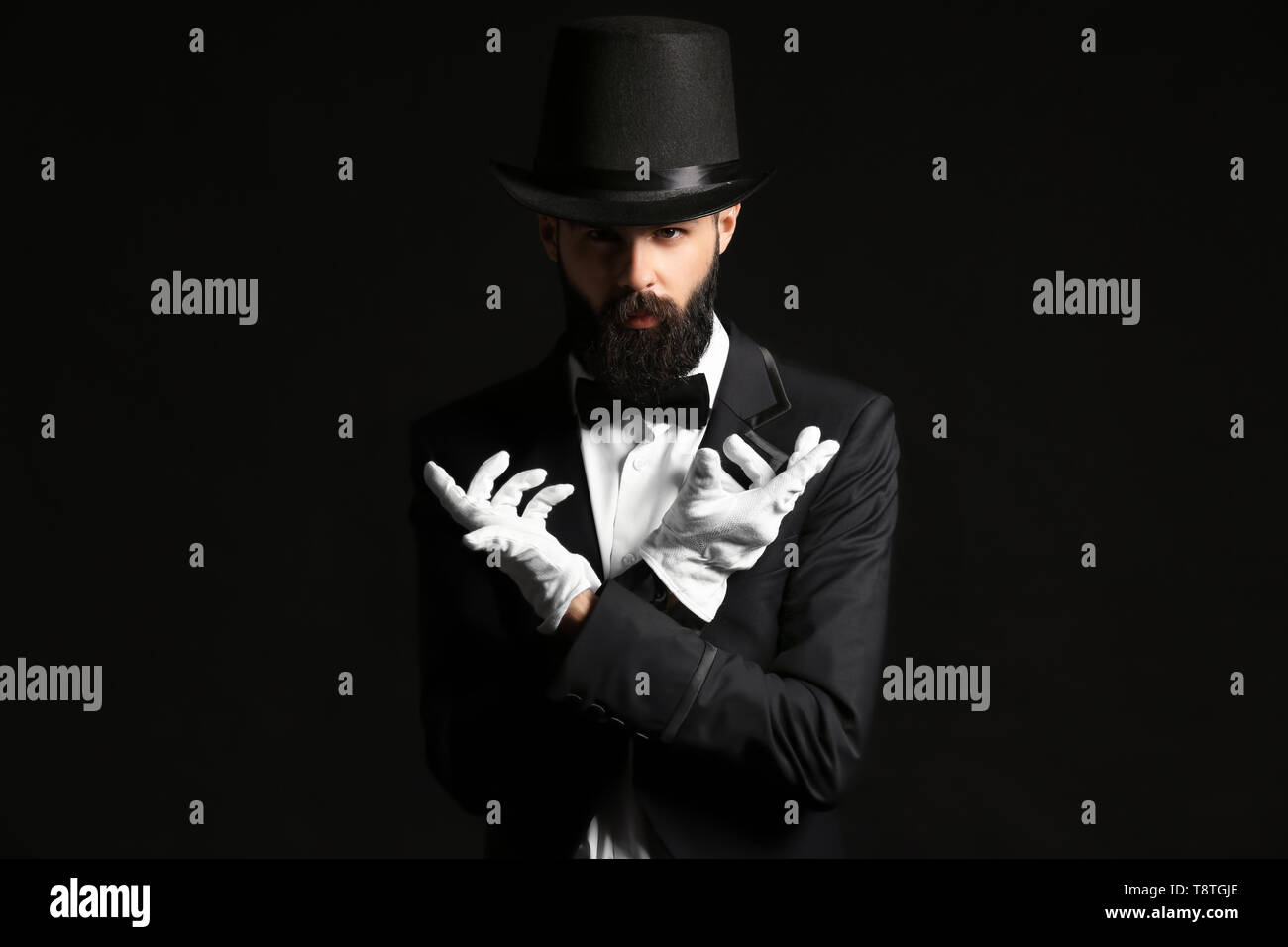 Male magician on dark background Stock Photo - Alamy