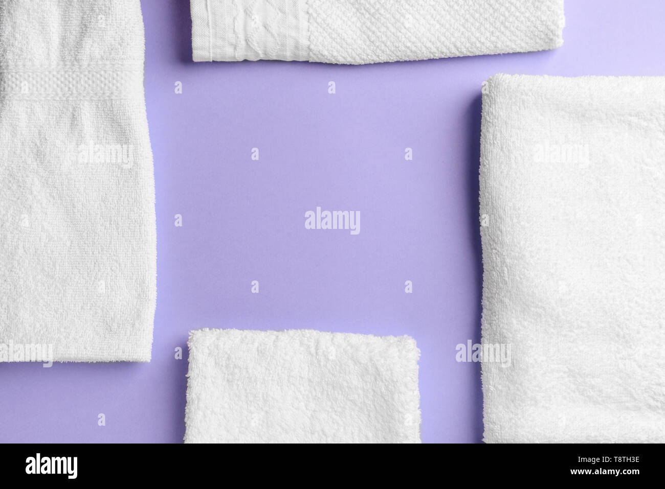 Clean soft towels on color background Stock Photo - Alamy