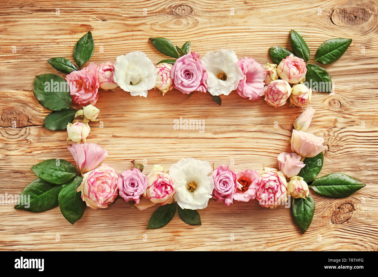Frame made of beautiful flowers on wooden background Stock Photo - Alamy