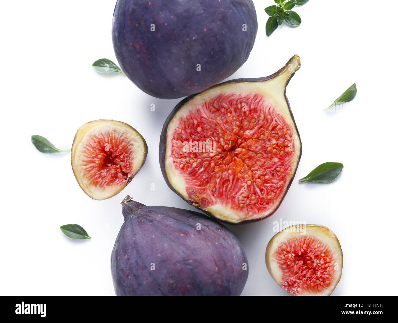 Whole and cut ripe figs on white background Stock Photo - Alamy