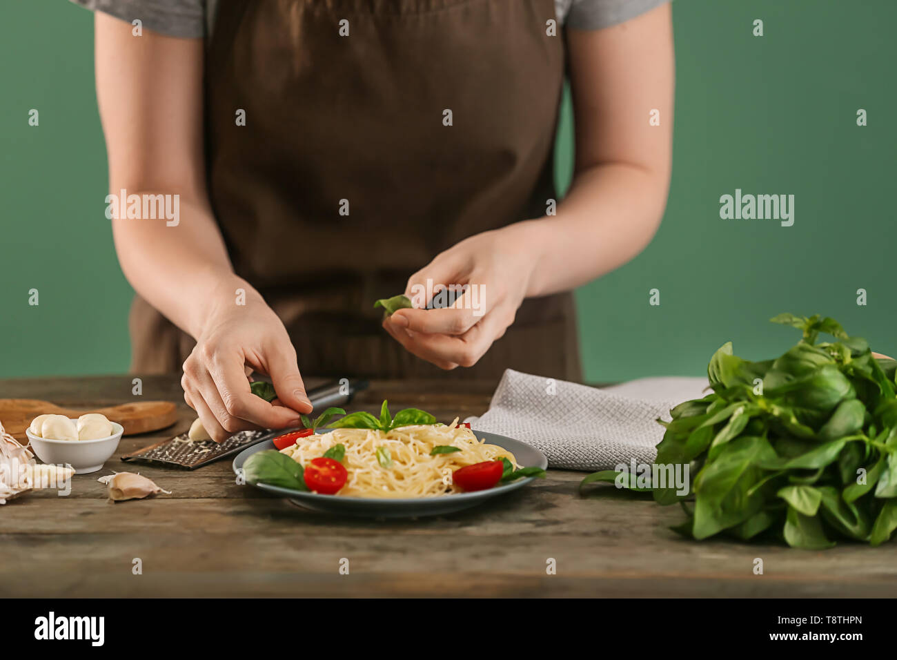 Female adding basil leaves italian hi-res stock photography and images ...