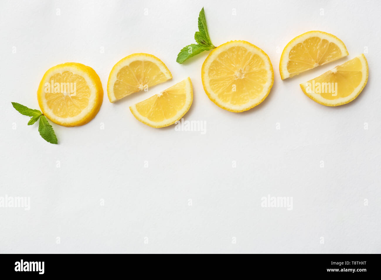 Flat lay composition with lemon slices on white background Stock Photo ...