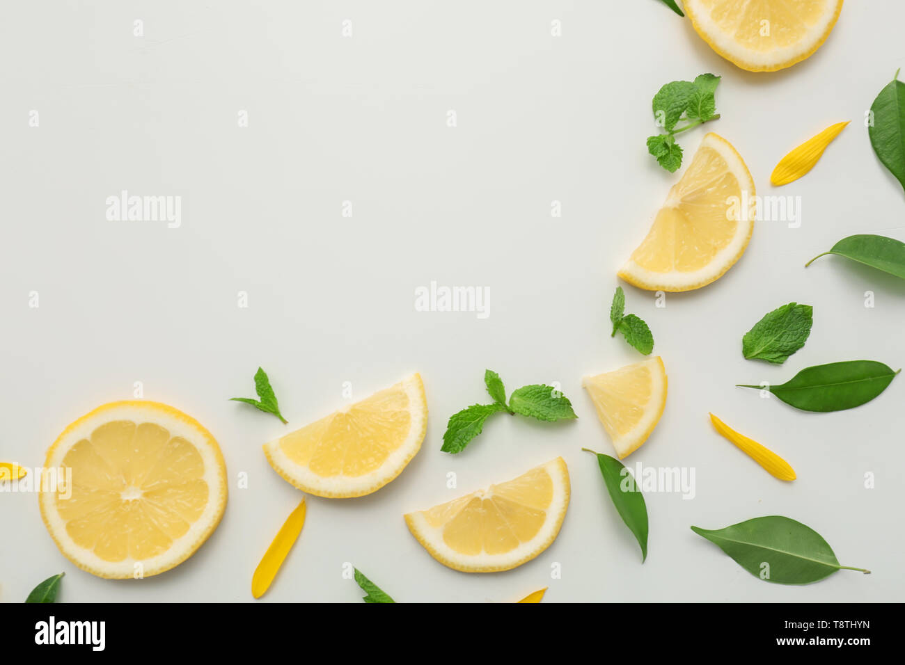Flat lay composition with lemon slices on white background Stock Photo ...