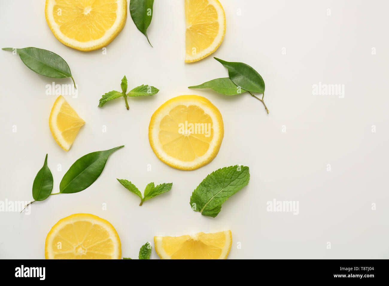 Flat lay composition with lemon slices on white background Stock Photo ...