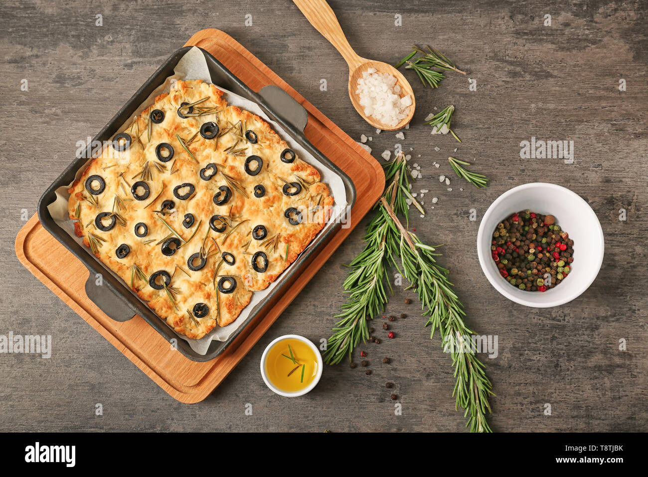 Baking tray with traditional Italian Focaccia on grey table Stock Photo ...