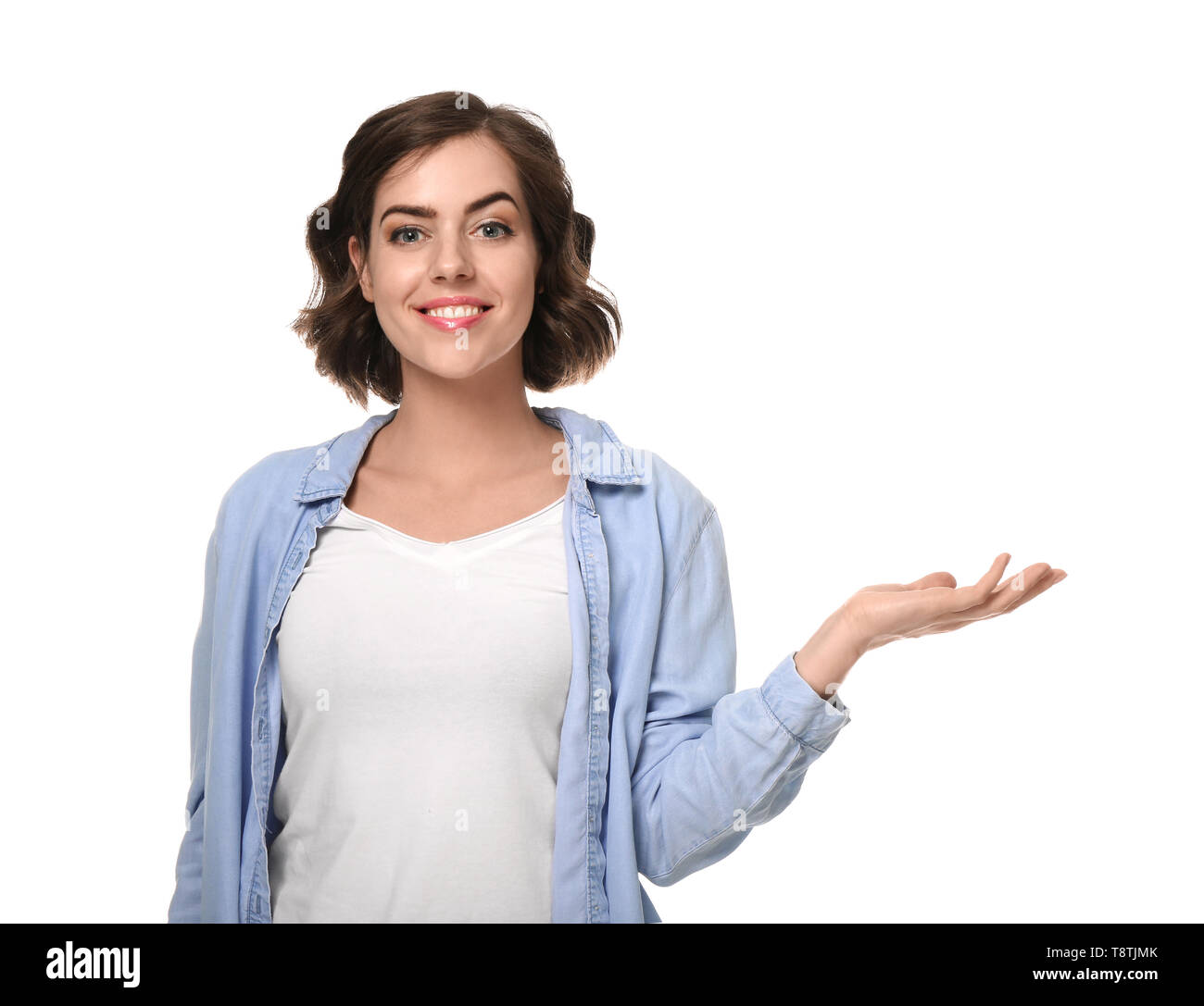 Portrait of beautiful young woman holding something on white background ...