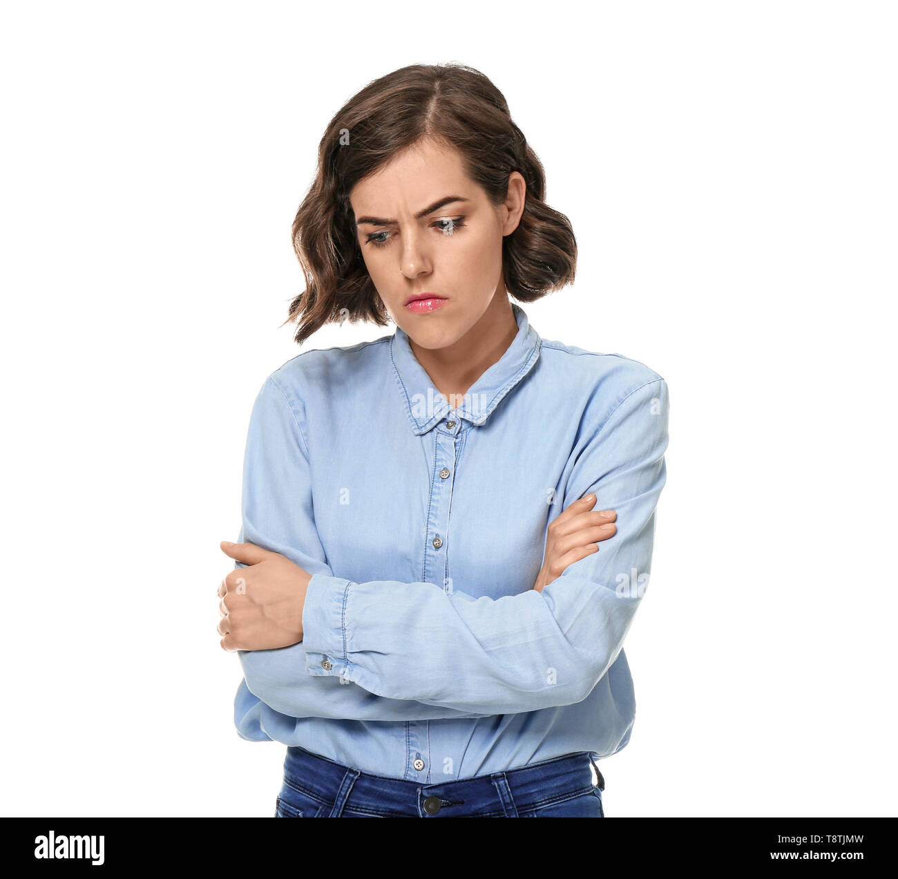 Portrait of grumpy young woman on white background Stock Photo - Alamy