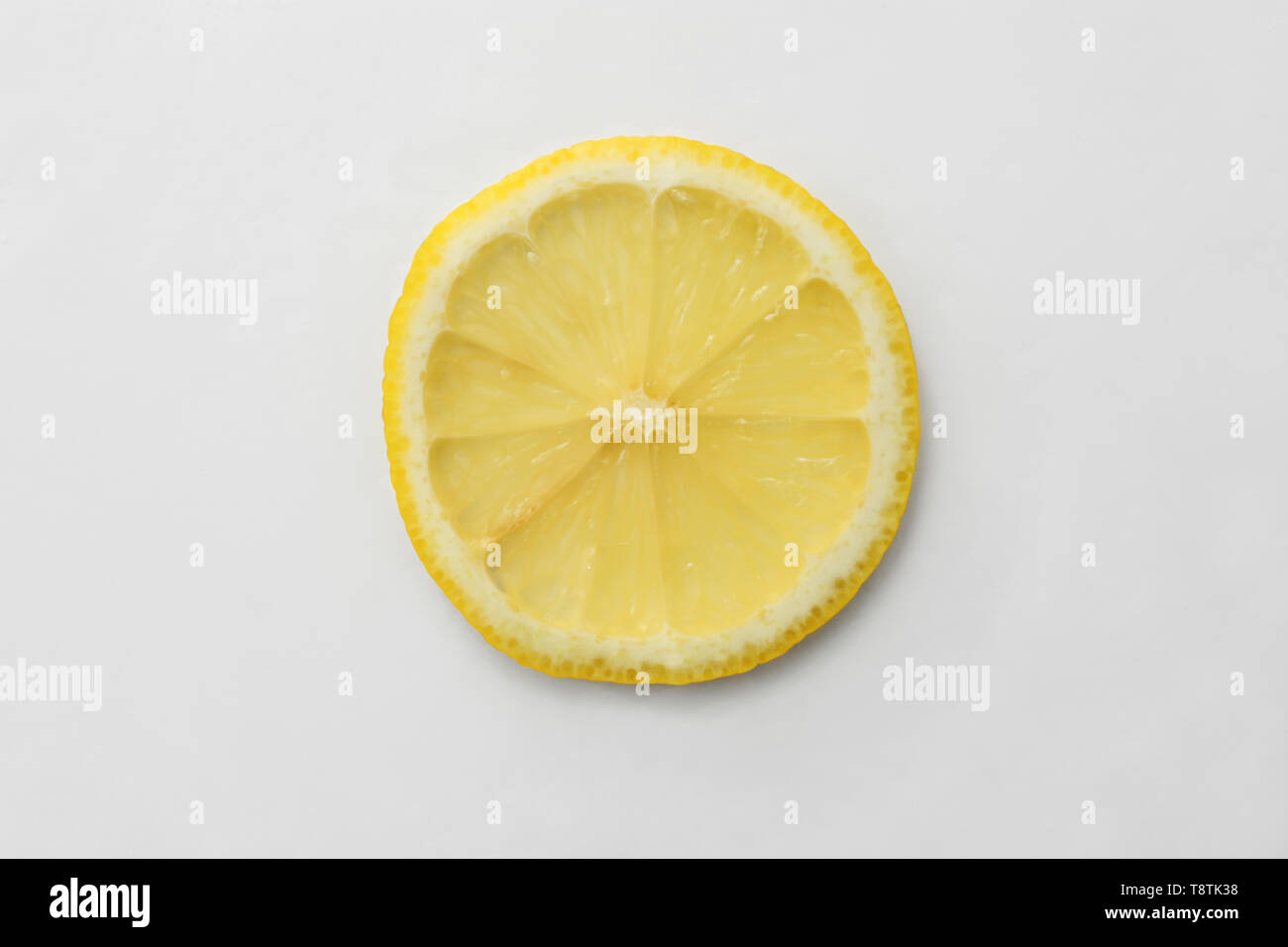 Slice of ripe lemon on white background Stock Photo - Alamy