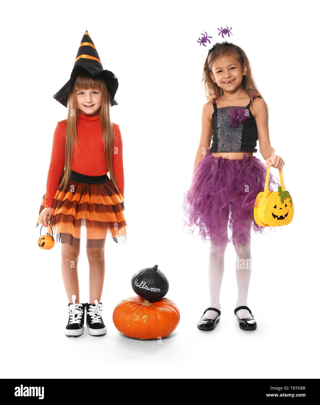 Cute little girls dressed for Halloween on white background Stock Photo ...