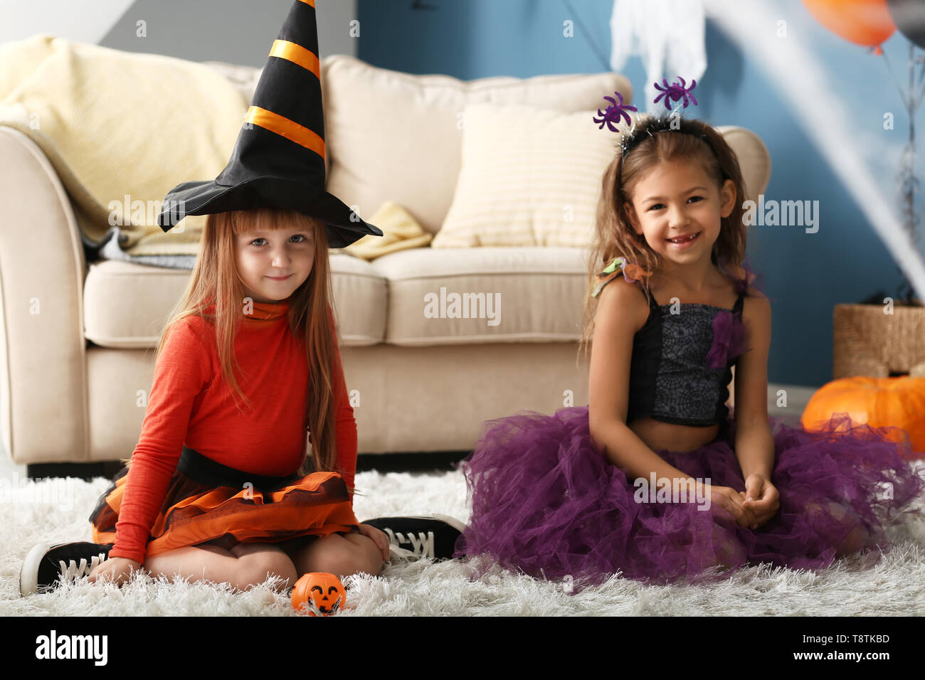 Cute little girls in Halloween costumes at home Stock Photo - Alamy