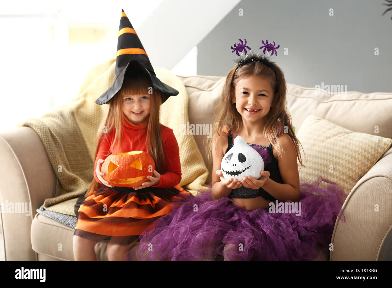 Cute little girls in Halloween costumes at home Stock Photo - Alamy