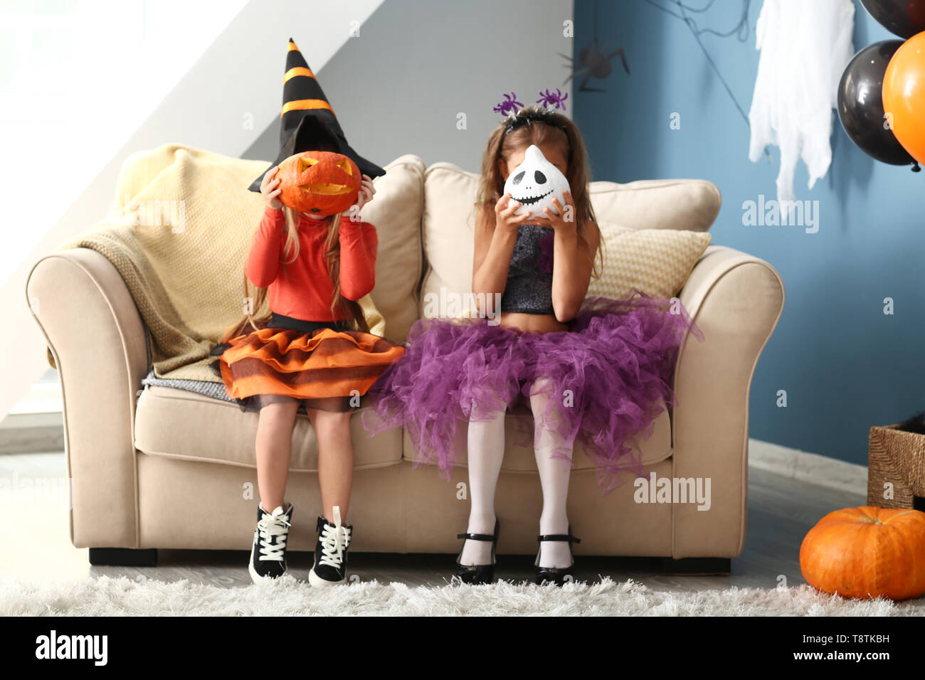 Cute little girls in Halloween costumes at home Stock Photo - Alamy