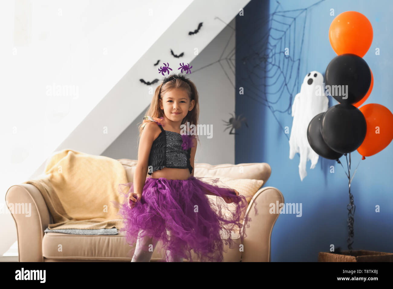 Cute little girl in Halloween costume at home Stock Photo - Alamy