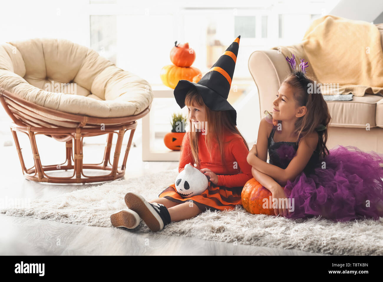 Cute little girls in Halloween costumes at home Stock Photo - Alamy