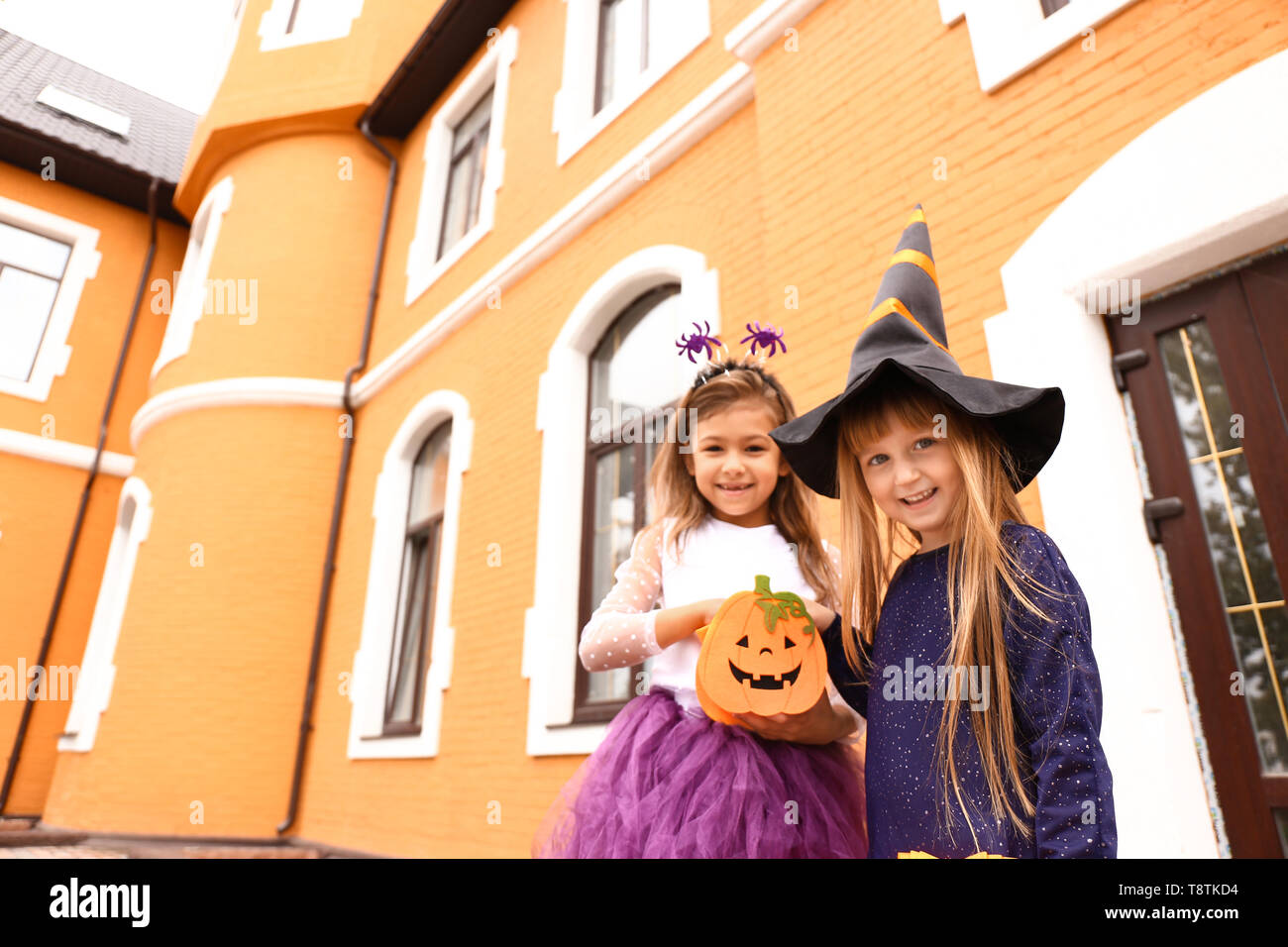 Cute little girls in Halloween costumes outdoors Stock Photo - Alamy