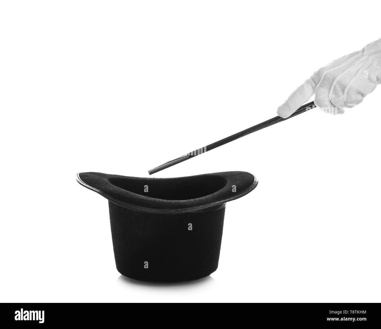 Magician showing trick with hat on white background Stock Photo - Alamy