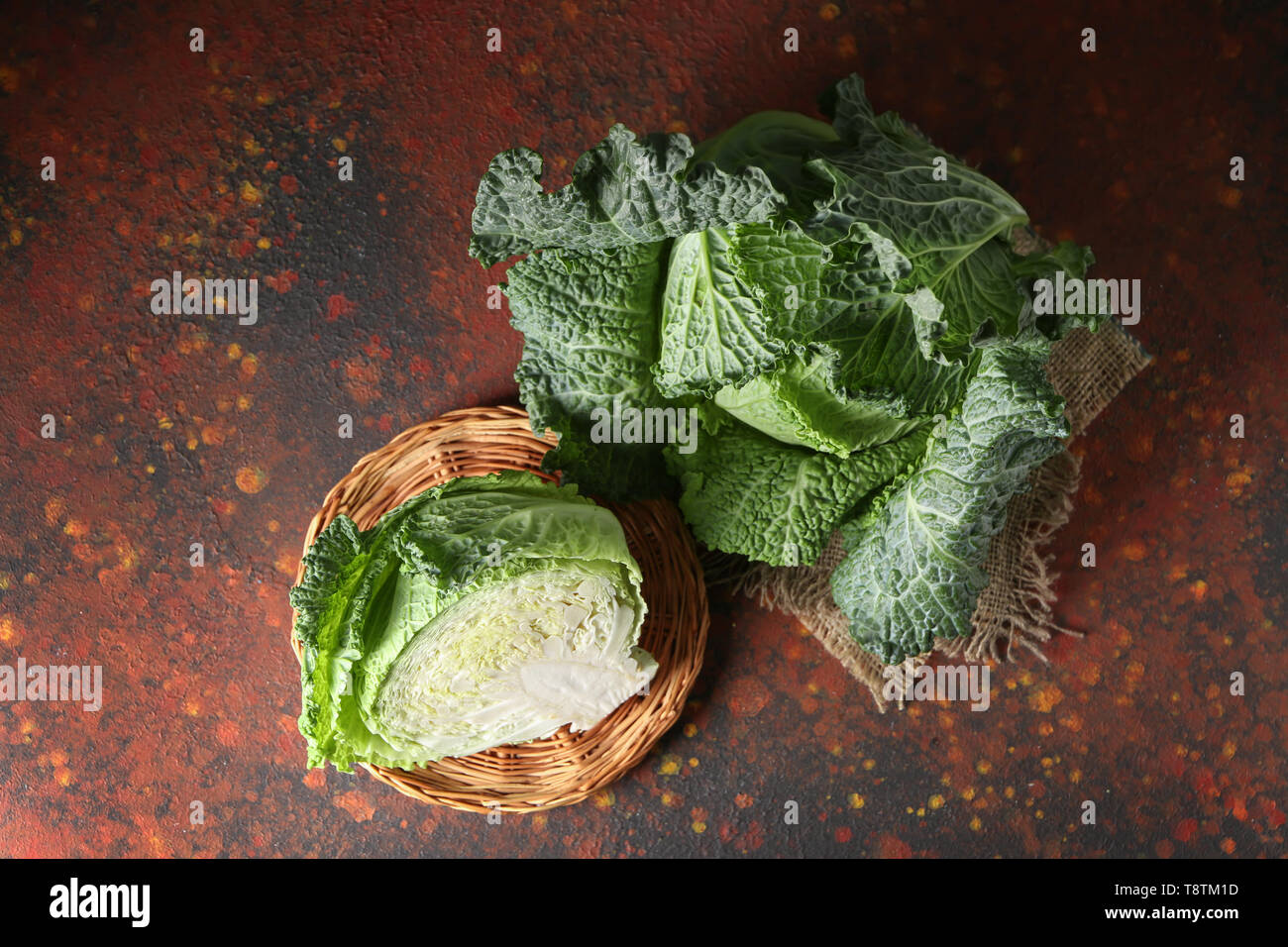 Whole and cut savoy cabbages on color table Stock Photo - Alamy