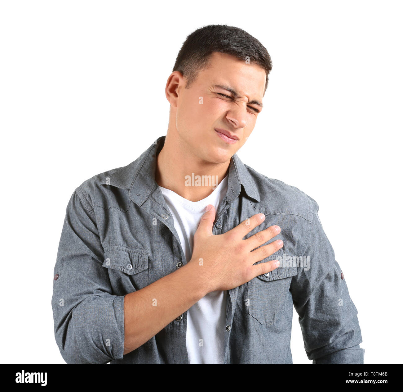Young man suffering from heart attack on white background Stock Photo ...