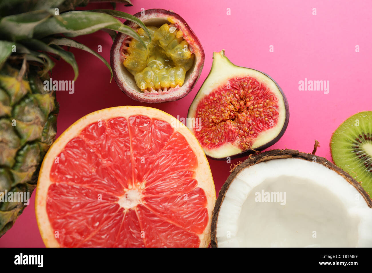 Different tropical fruits on color background Stock Photo - Alamy