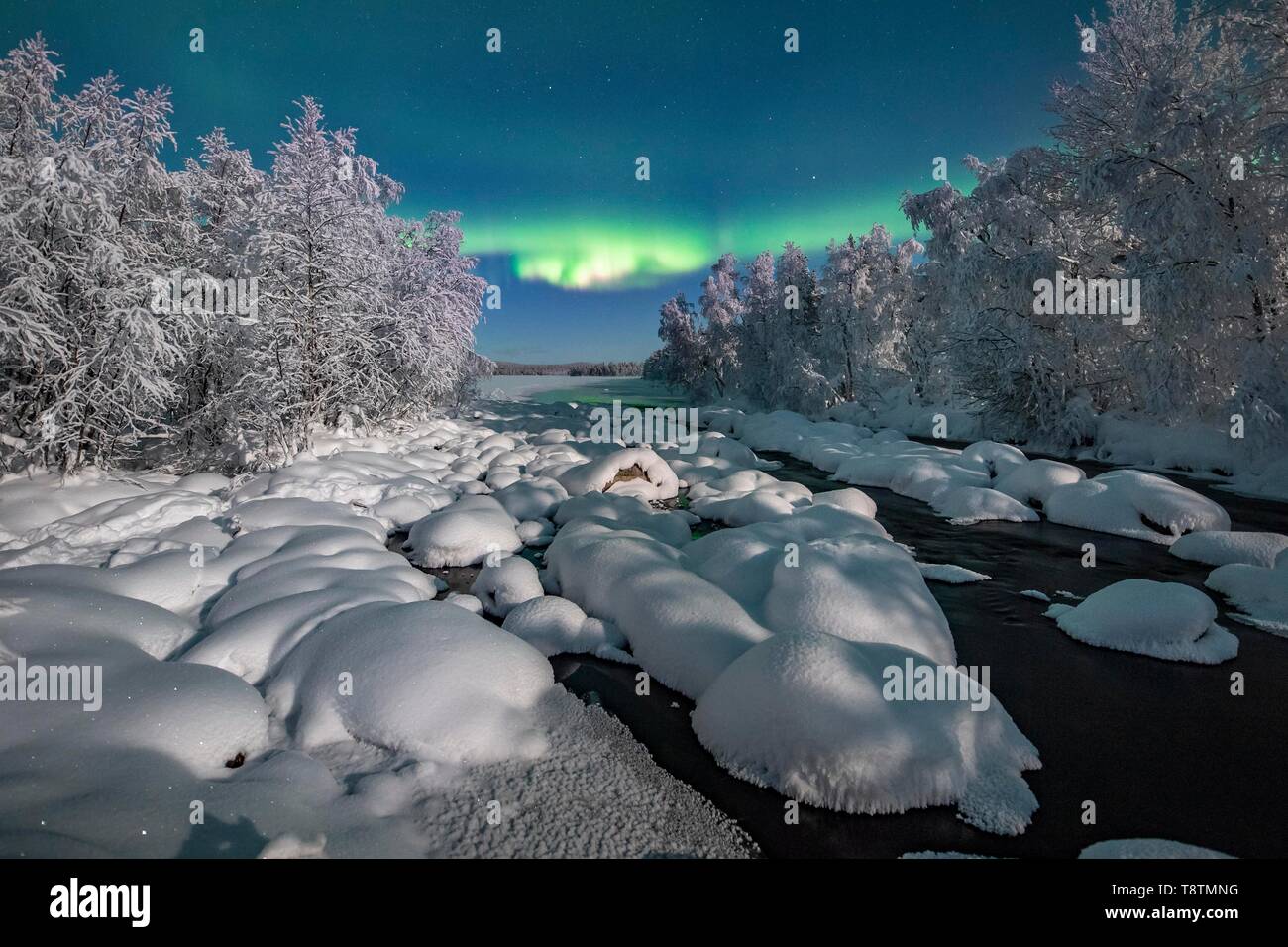Northern Lights (Aurora Borealis) over snowy river landscape, Pallas ...