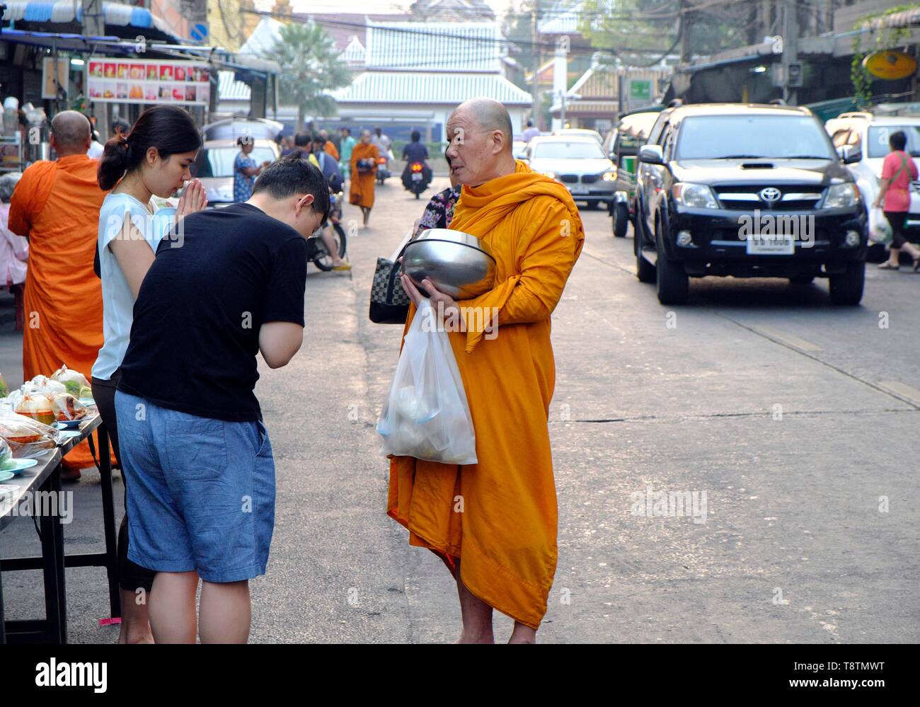Faithful Thais bow in front of a begging monk, Bangkok, Thailand Stock ...