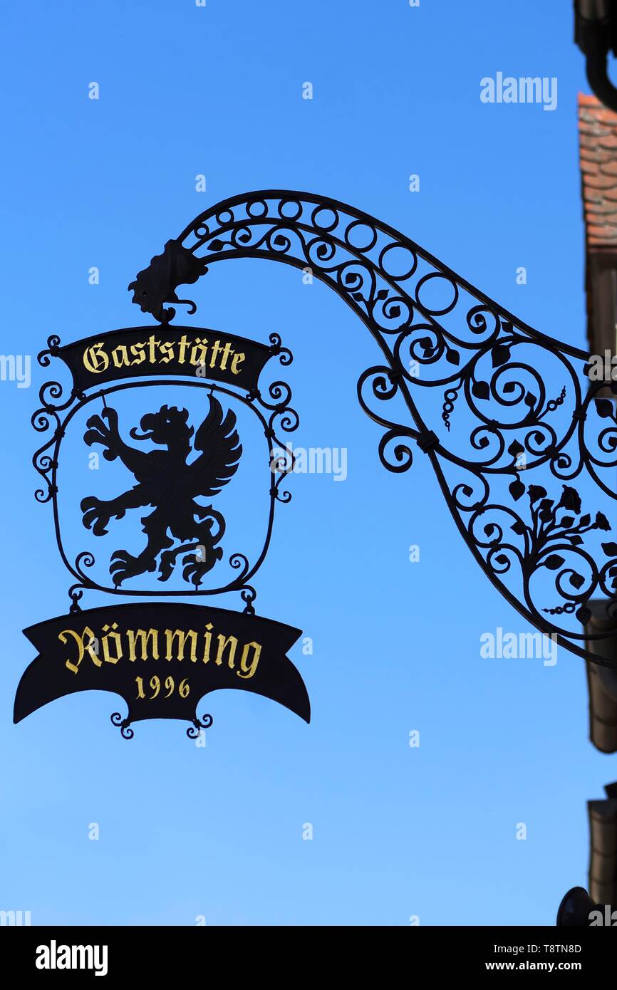 Hanging shop sign of a restaurant with black eagle, blue sky, Erlangen ...