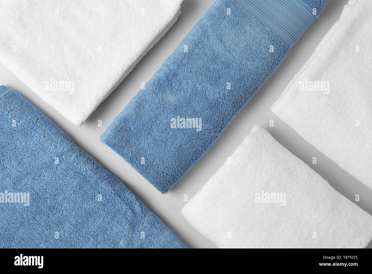 Clean soft towels on light background Stock Photo - Alamy
