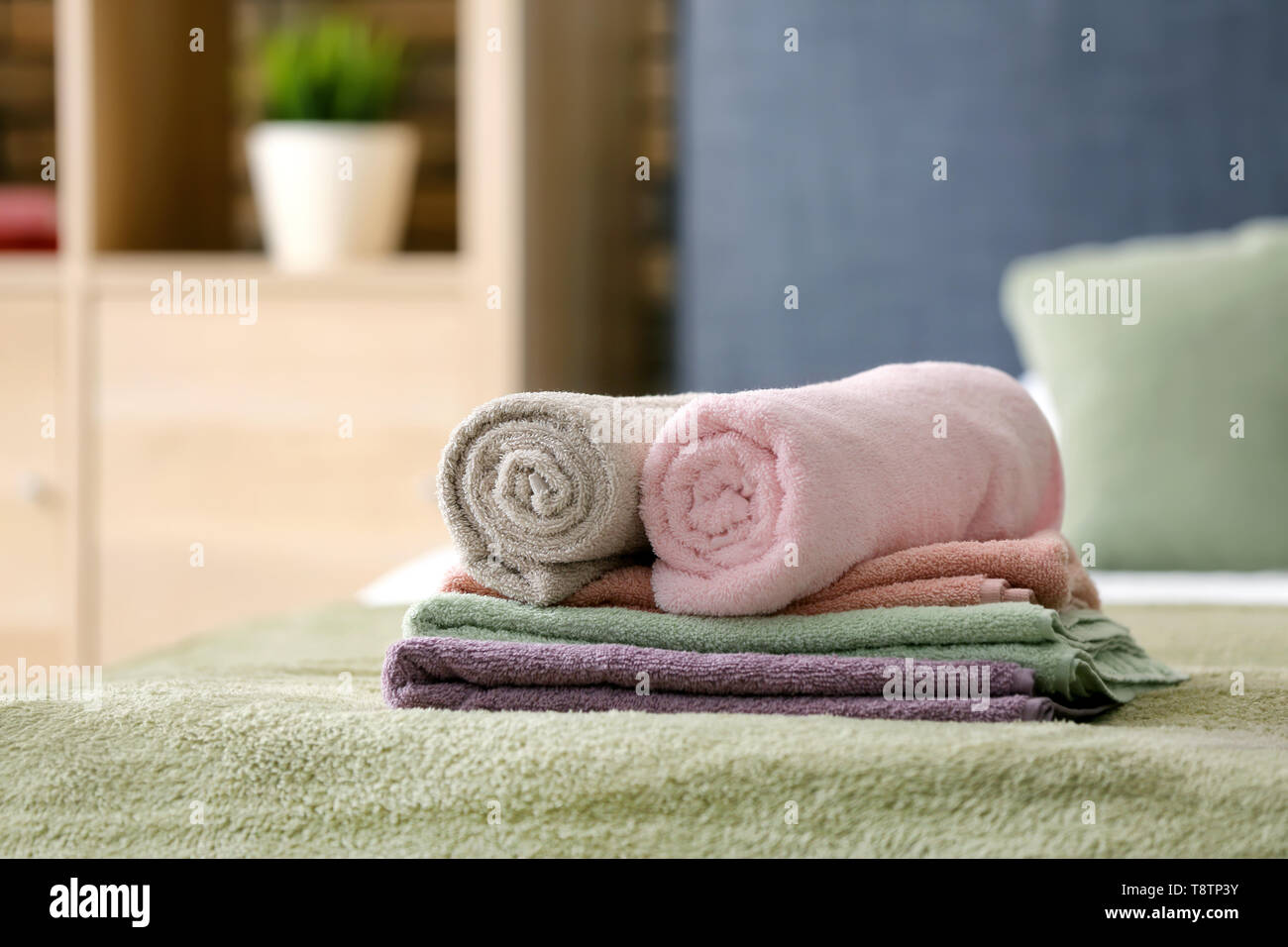Clean soft towels on bed in room Stock Photo - Alamy